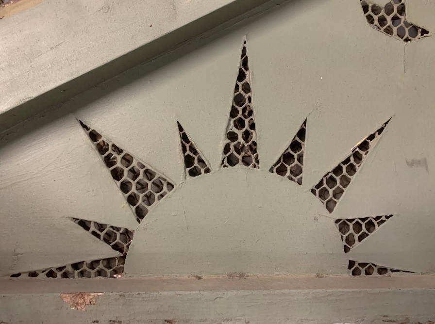 Two roof gable ends with sunshine motif cut in galvanised sheet ...