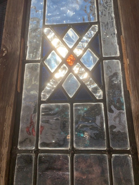 Detail of original red, blue and clear leadlight panel in stripped ...